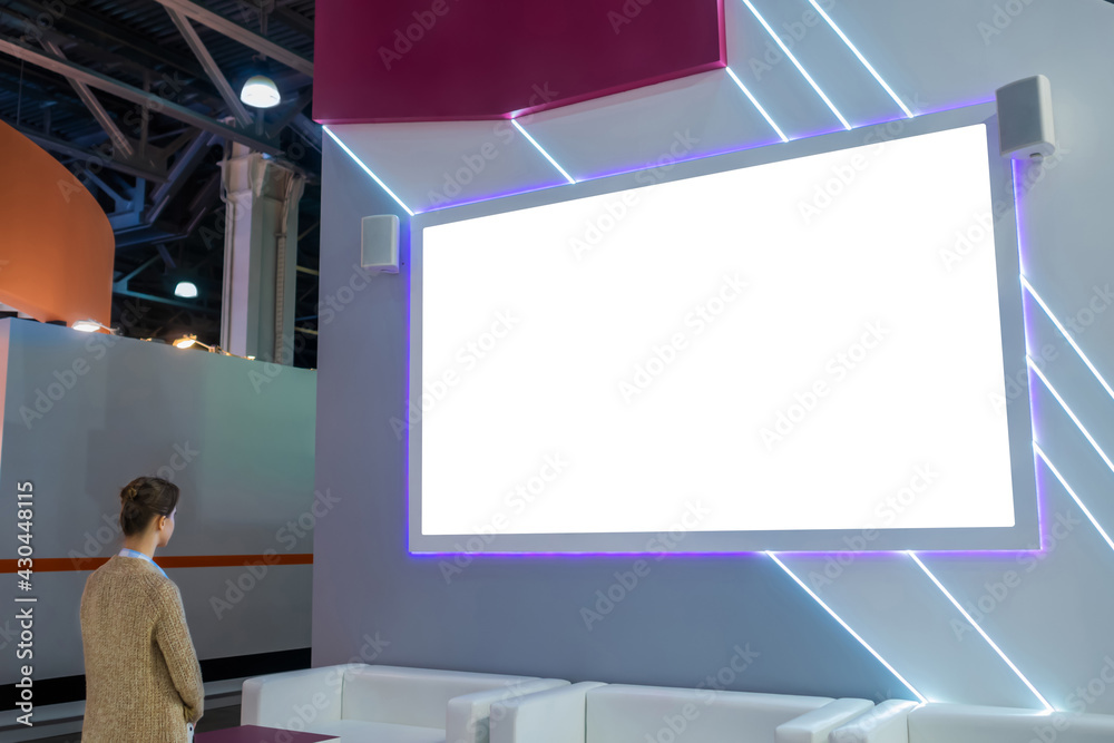 Mockup image: woman looking at blank large white interactive wall ...