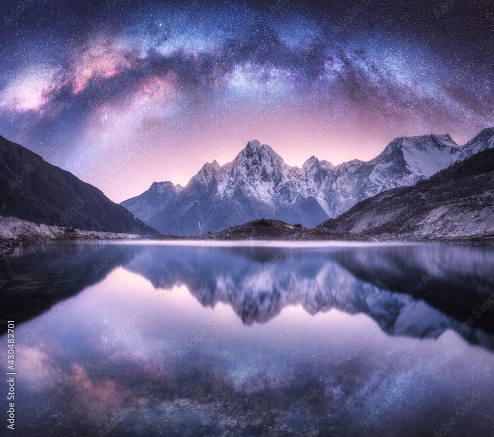 Milky Way over snowy mountains and lake at night. Landscape with snow ...