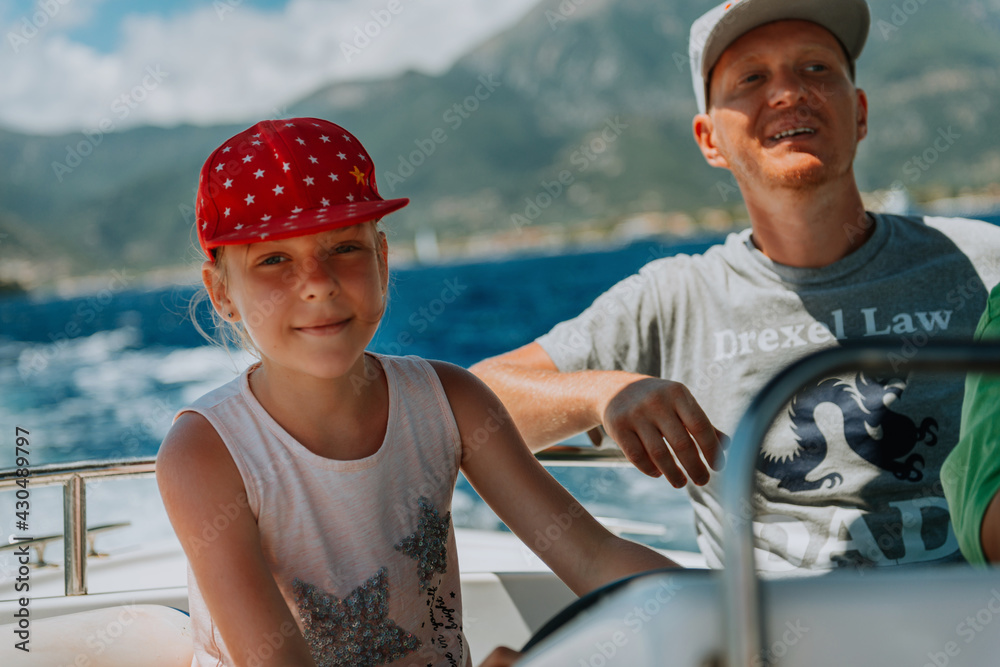 beautiful girl drive the speed boat in Greece. Little girl on a private ...