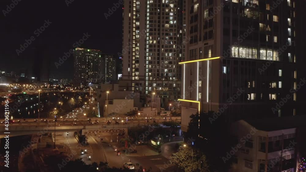 aerial tripod view across busy traffic bridge and underpass at night ...