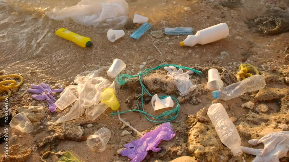 Close-up of disposable plastic, face masks and other debris on the ...