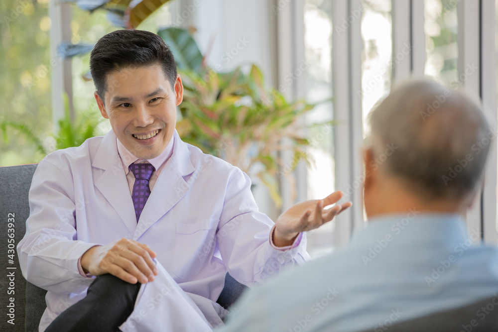 A young handsome male asian doctor wearing white lab coat with ...
