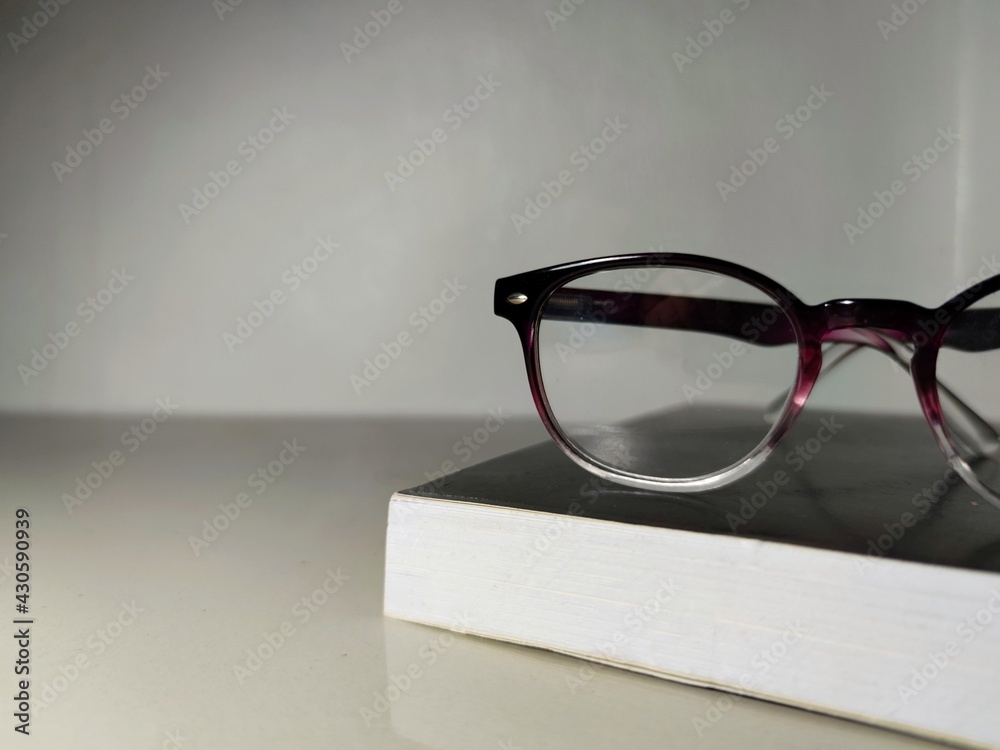 books with glasses on a table. Stock Photo | Adobe Stock