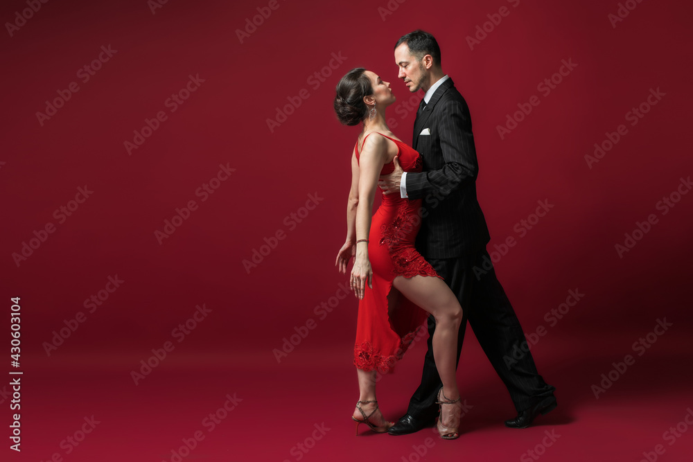 Couple of professional tango dancers in elegant suit and dress pose in ...