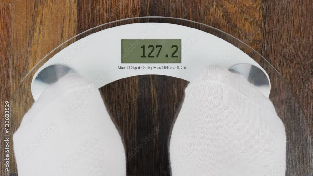 Vidéo Stock Overweight on bathroom scales digital display. Concept of ...
