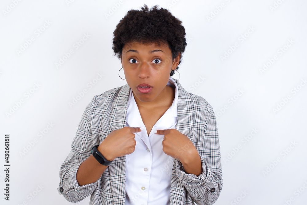 Embarrassed African American businesswoman with curly bushy hair wears ...