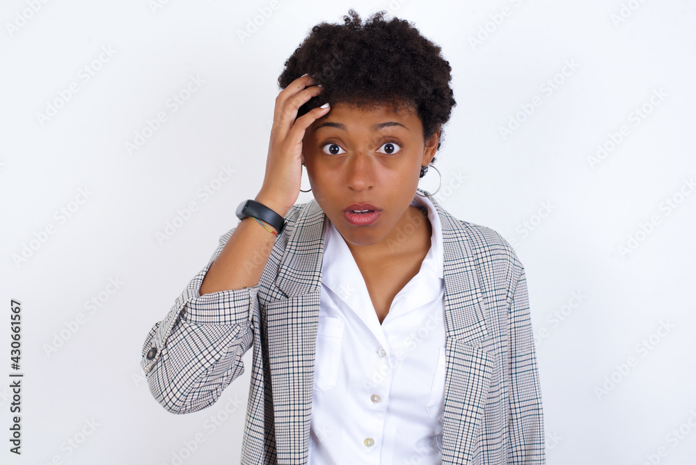 Embarrassed African American businesswoman with curly bushy hair wears ...