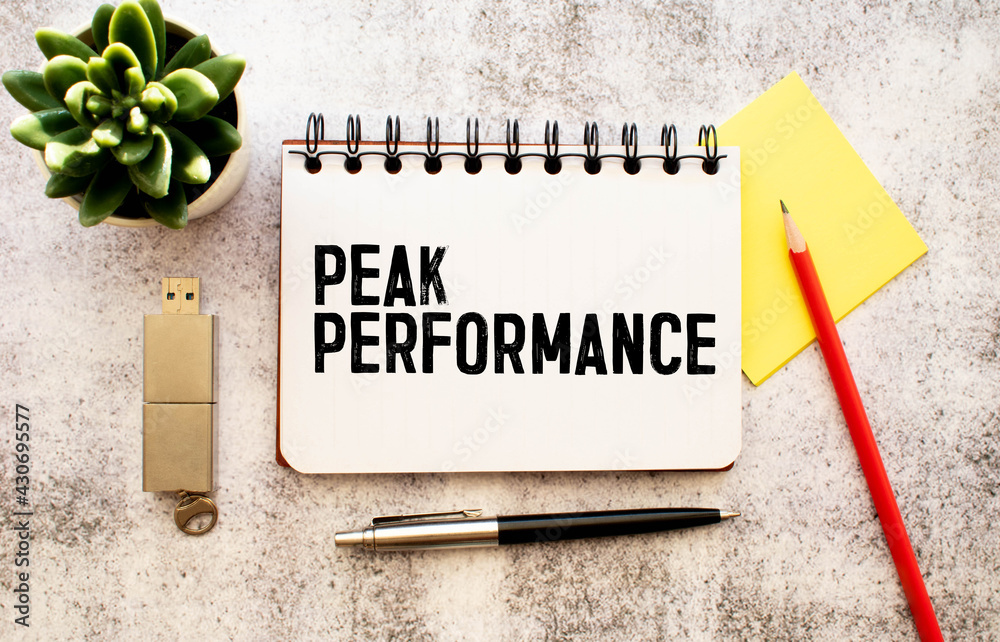 businesman hold notepad with text PEAK PERFORMANCE. White background ...