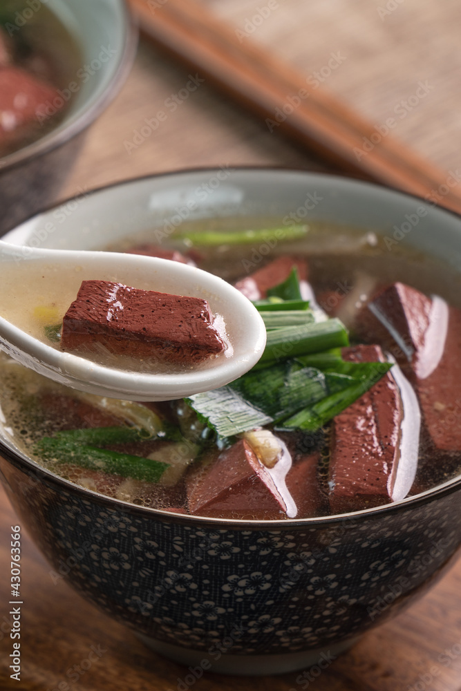Eating Taiwanese traditional pig blood soup with pickled mustard greens ...