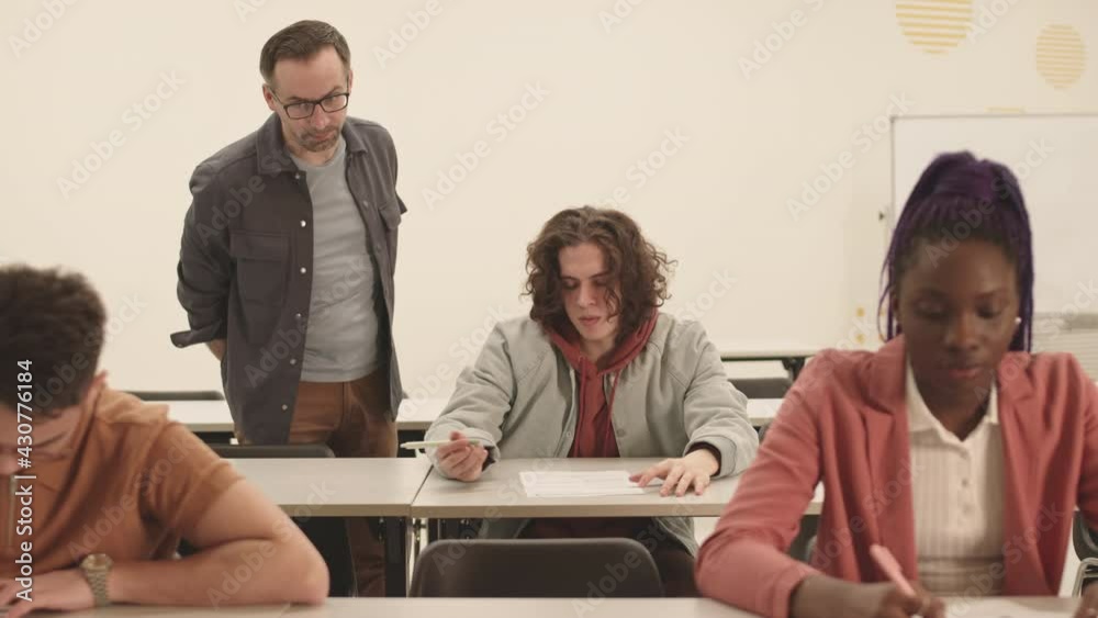 Locked-down of middle-aged Caucasian professor waking up male student ...