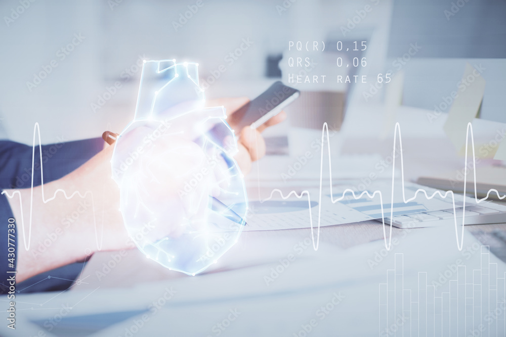 Double exposure of man's hands holding and using a phone and heart ...