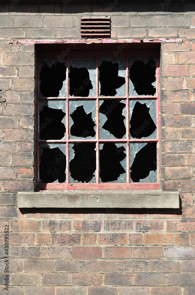 Broken Window in Brick Wall of Derelict Industrial Building Stock Photo ...