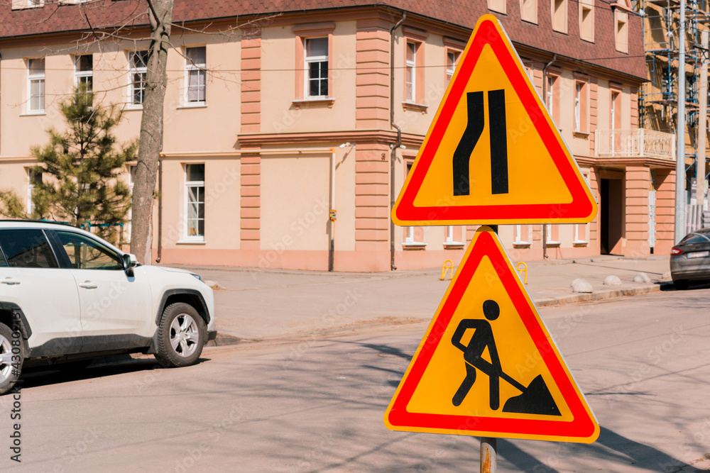 Traffic warning sign for a road narrowing on the left and triangle road ...