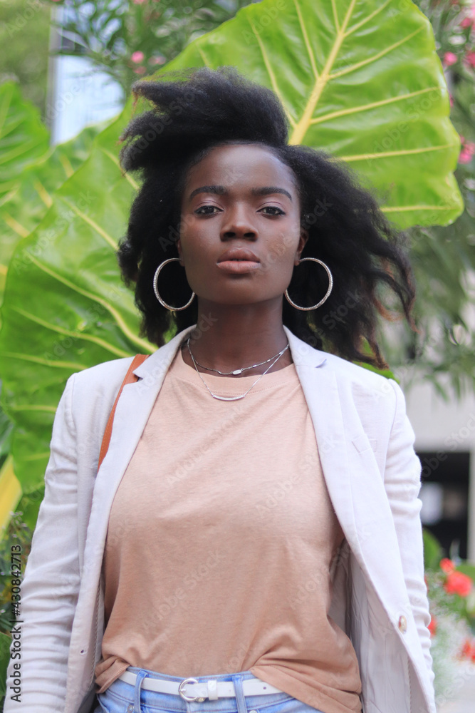 Close up of serious woman walking, erratic hairstyle, close up portrait ...