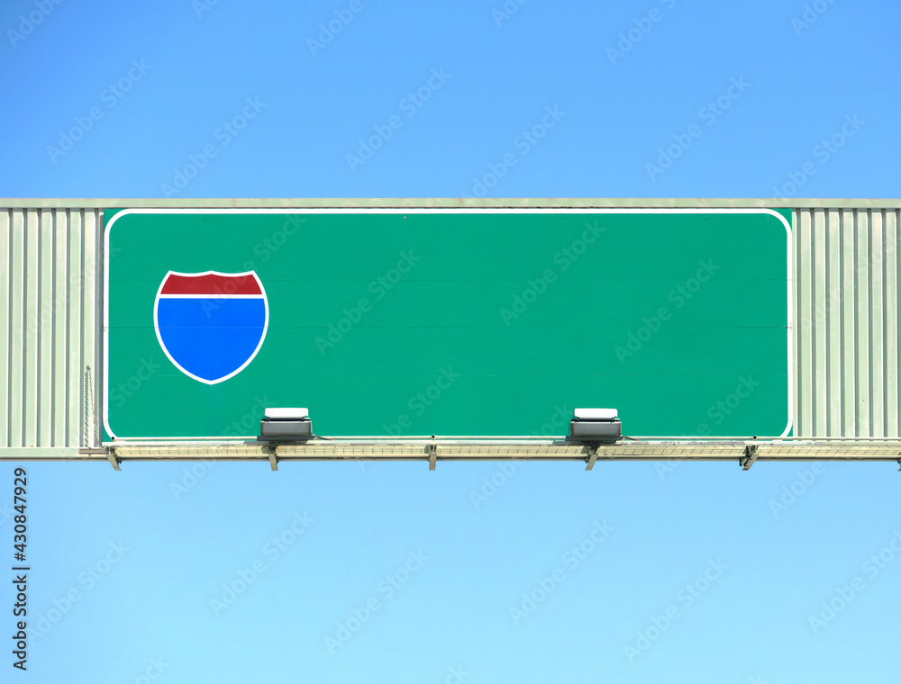 American interstate highway overhead road sign. Blue sky background ...