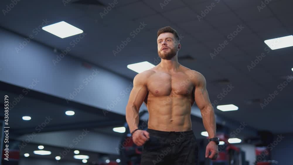 Young bodybuilder weightlifter with an ideal body. Handsome sportsman ...