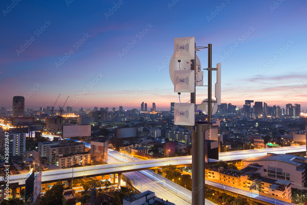 Telecommunication tower with 5G cellular network antenna on night city ...
