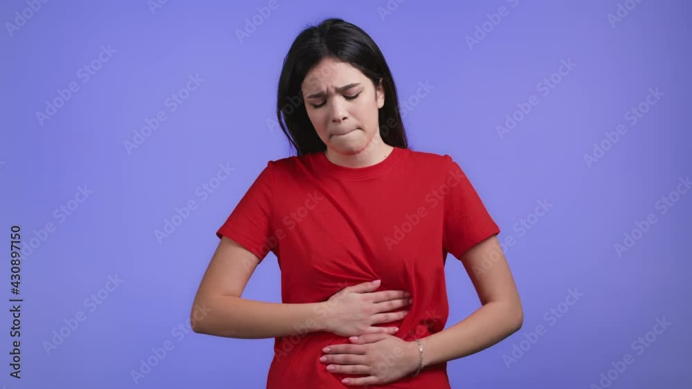 Woman squeezing belly with hands because of abdominal pain. Lady ...