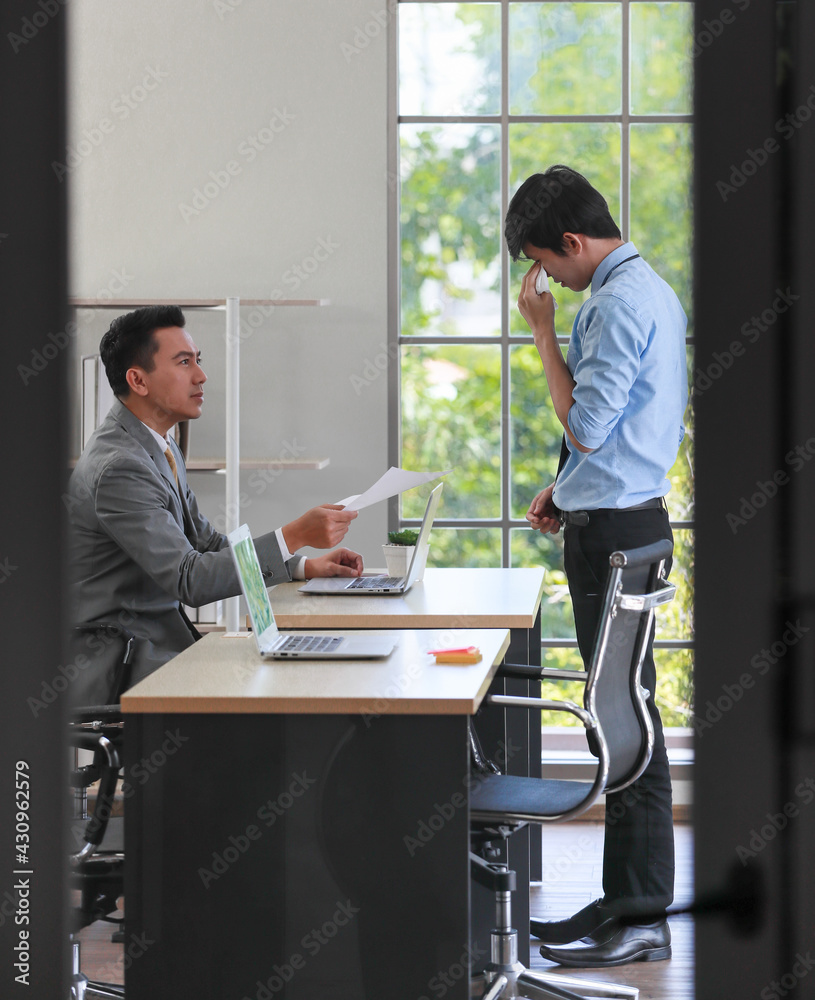 A young junior employee feels sad and crying when the boss blame and ...