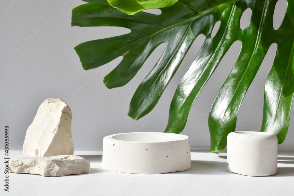 Three white catwalks with a geometric concrete figure and a large ...