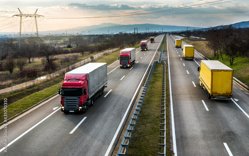 Convoys or caravans of transportation trucks passing on a highway at ...