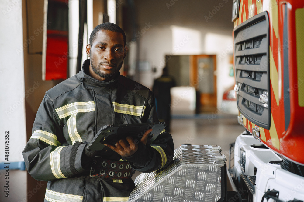Portrait of a firefighter standing in front of a fire engine Stock ...