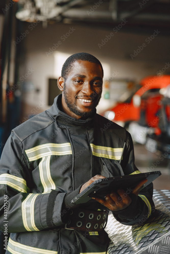 Portrait of a firefighter standing in front of a fire engine Stock ...