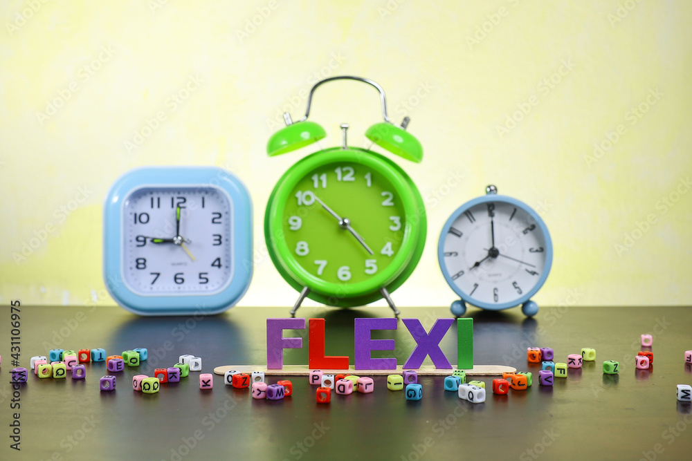 Flexi hour concept. FLEXI letterings with three alarm clock at the back ...