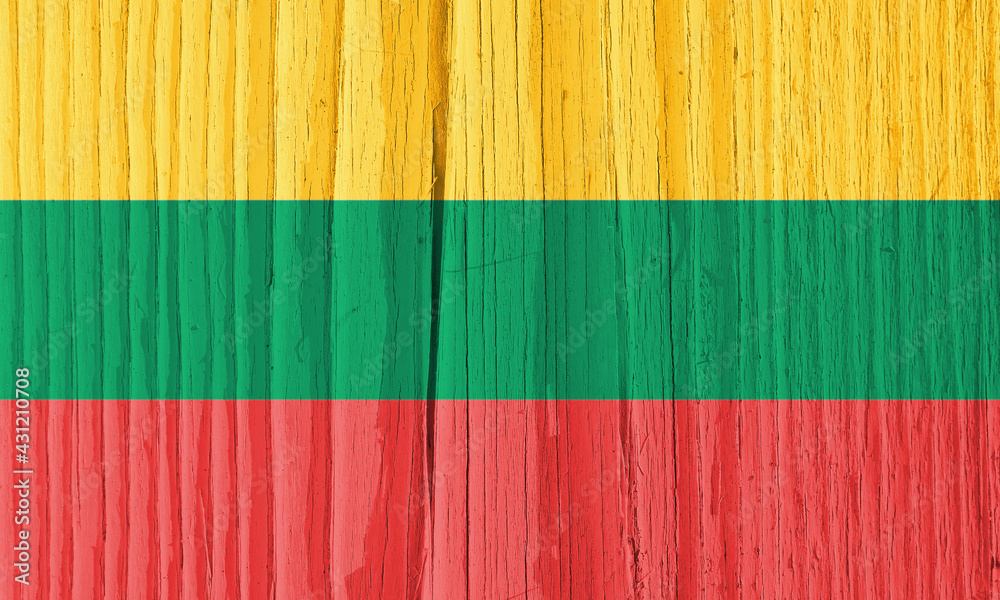 The flag of Lithuania on dry wooden surface, cracked with age. Light ...