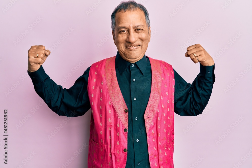 Middle age indian man wearing traditional indian clothes showing arms ...