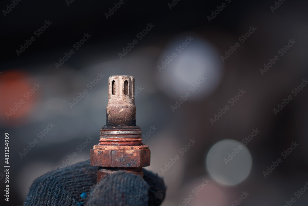 Mechanic hold in hand broken oxygen sensor of exhaust system, check faults in emission system ...