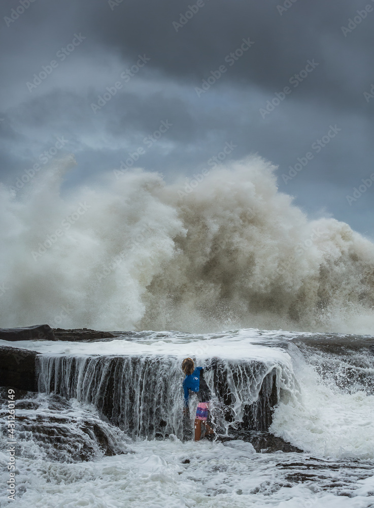 Person hiding behind ocean rock pool known as the 'barrel wall' as ...