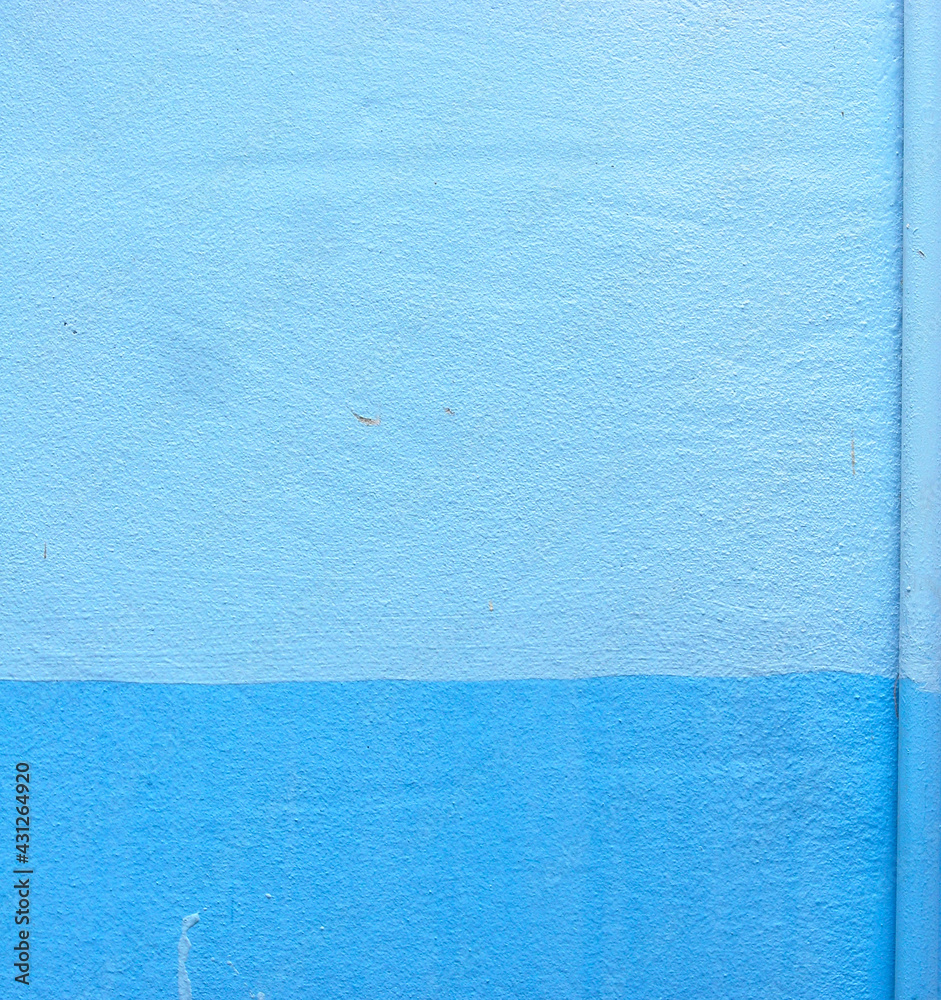 Light blue and dark blue plaster walls There is a blue PVC pipe on the ...