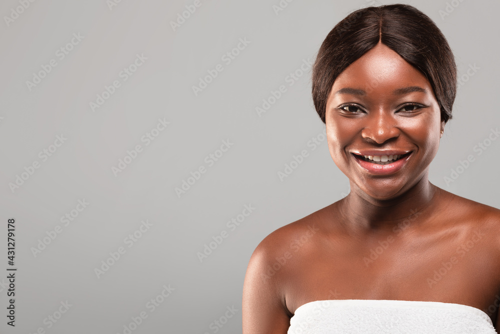 Attractive black female woman with perfect smooth skin posing over gray ...