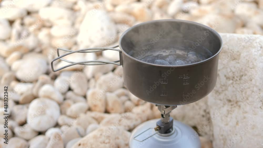 Boiling Water in Lightweight Titanium Pot on Gas burner Stove. Cooking ...