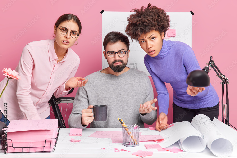 Professional team of architects collaborate on engineering project look ...