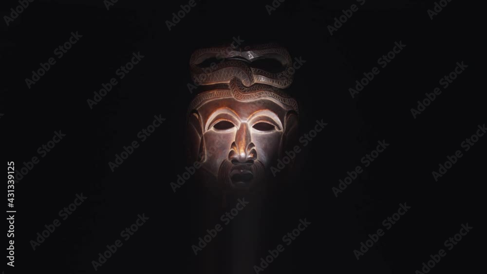 Creepy, masked cultist standing in a dark room. Scary horror scene ...