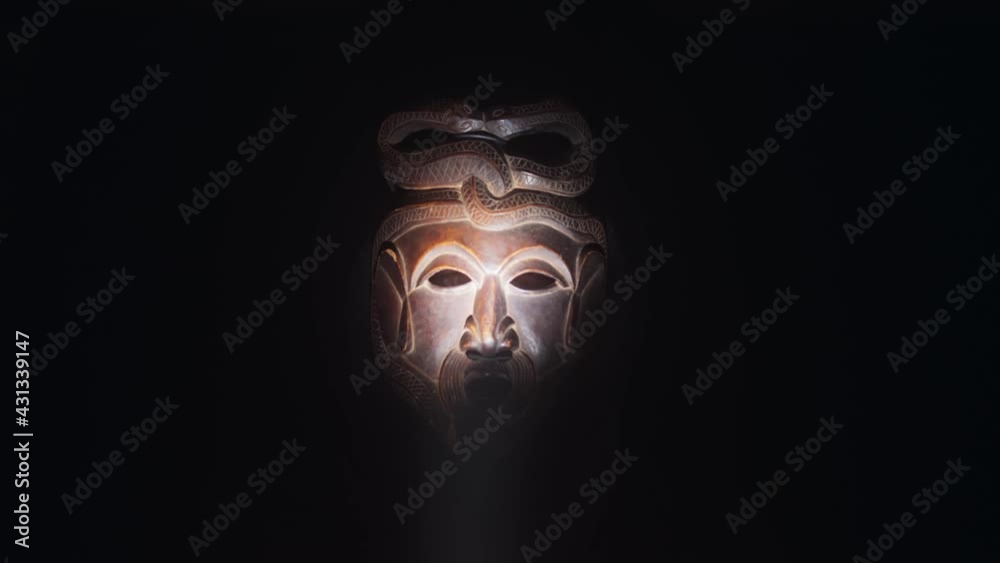 Creepy, masked cultist standing in a dark room. Scary horror scene ...