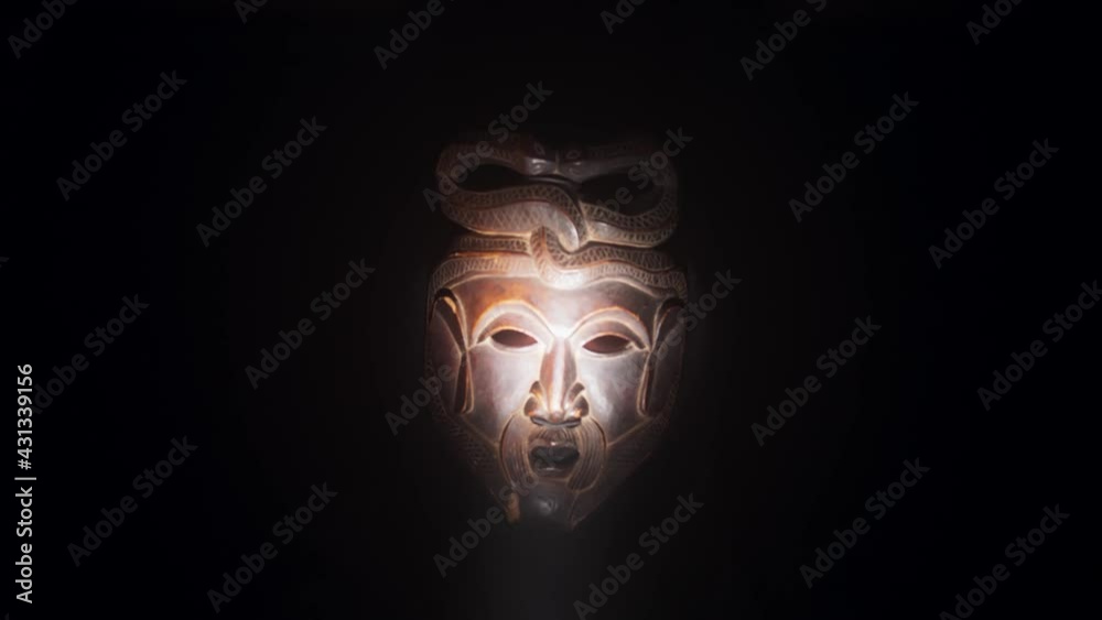 Creepy, masked cultist standing in a dark room. Scary horror scene ...