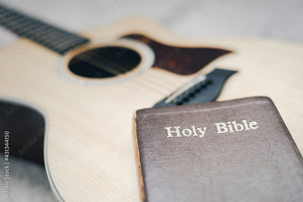 Christians worship God with a guitar with the Holy Bible. reading the ...