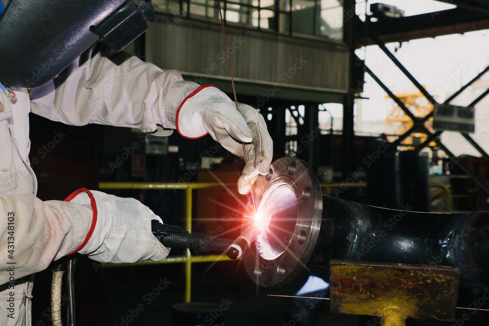 Closeup Welder is welding Tungsten Inert Gas welding with spark light ...