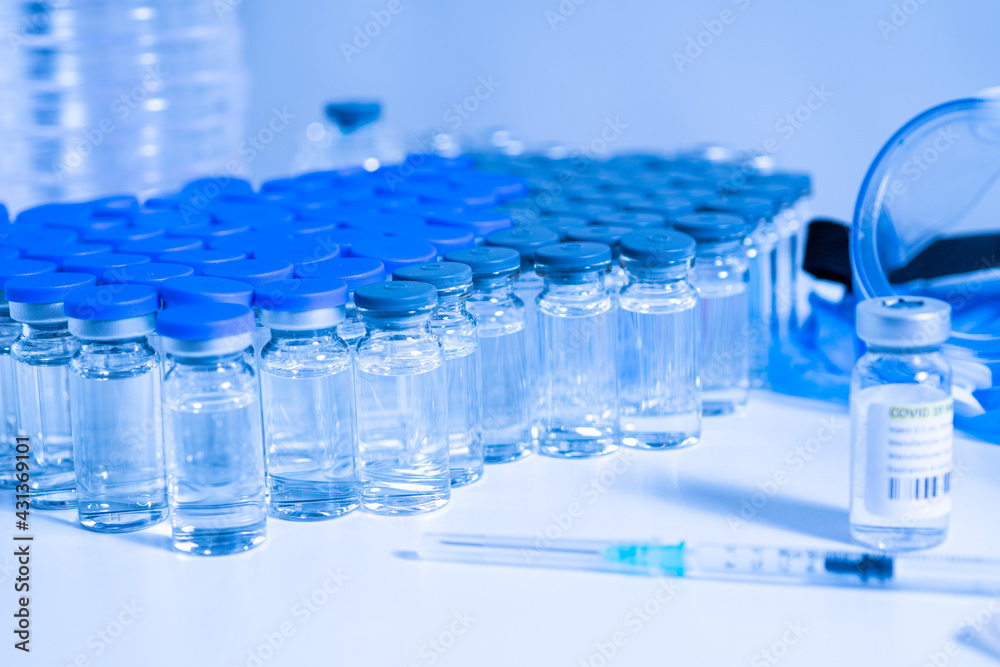 Glass bottle vial and syringe with Covid-19 Coronavirus vaccine in a ...