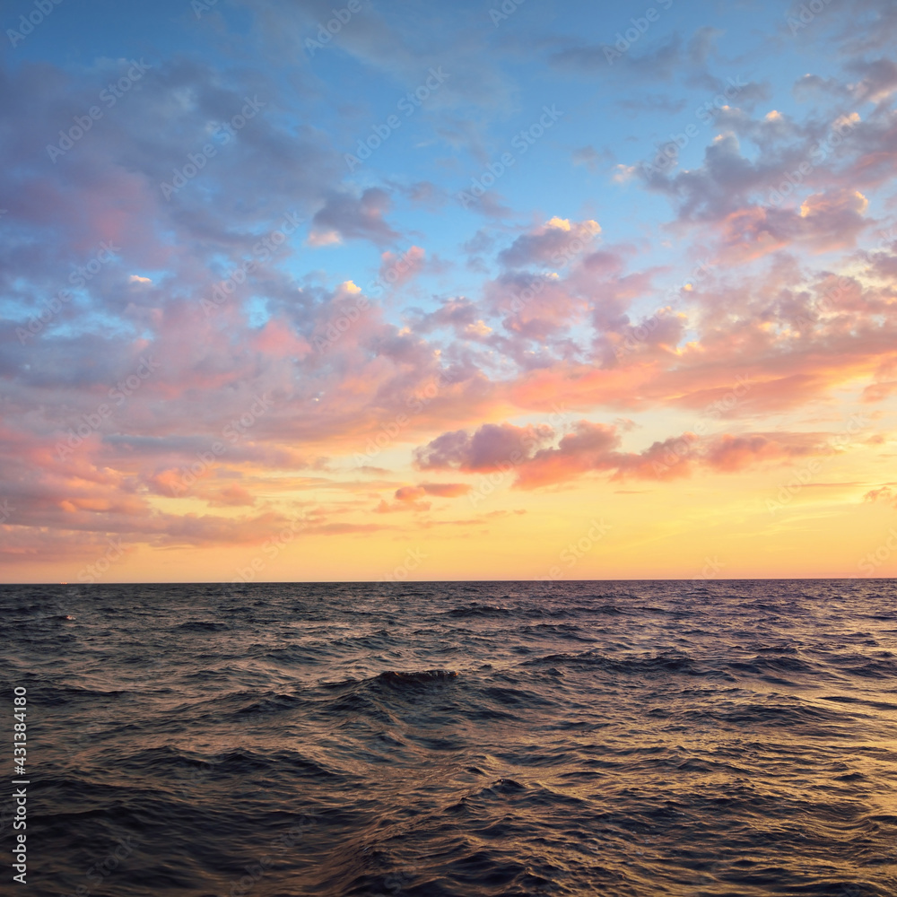 Colorful glowing sunset clouds above the open sea, a view from the ...