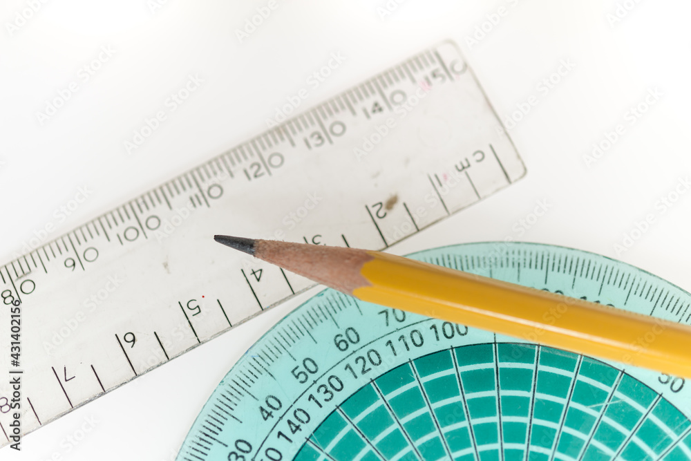 detail of an old, well used aqua green protractor, clear plastic ruler ...