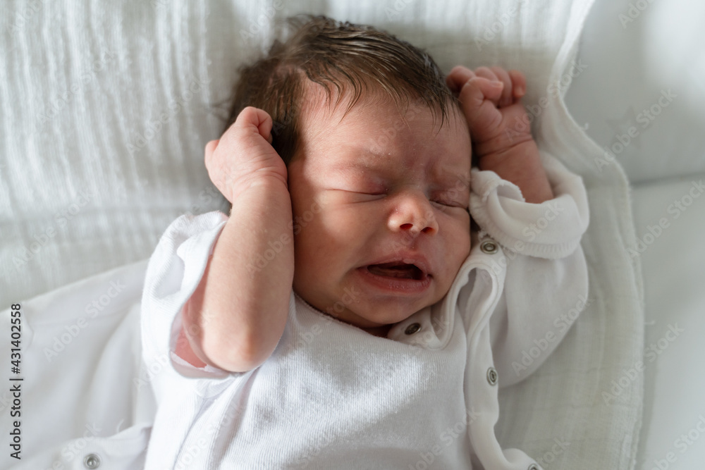 Top view crying four weeks old small caucasian baby with painful ...