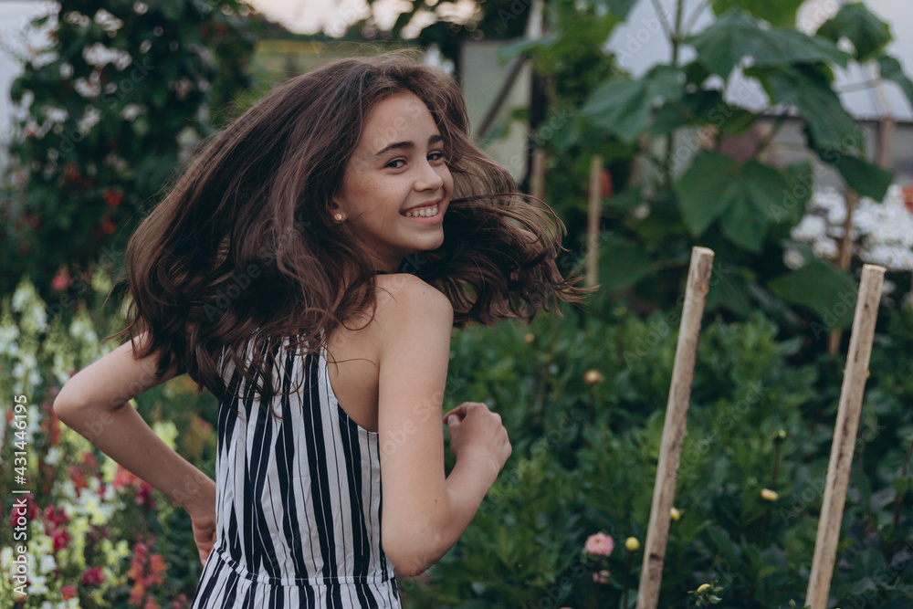 Cute 13-year-old child girl running in the flower field with happiness ...