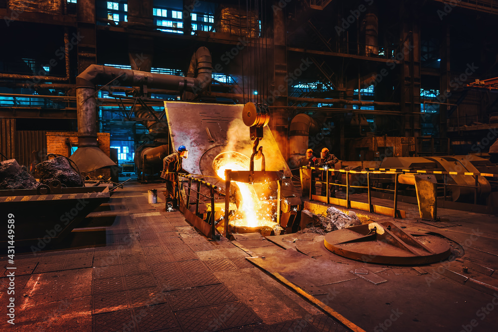Foundry workshop interior, molten iron pouring from blast furnace into ...