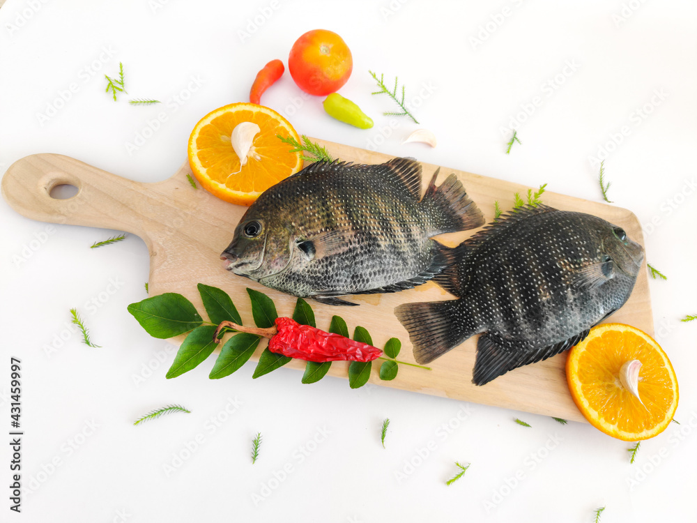 pearl spot fish /Karimeen decorated with herbs and fruits. isolated on ...