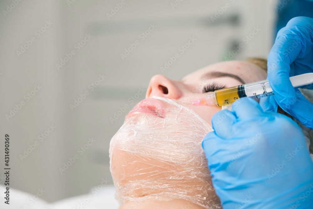 PRP therapy in beauty clinic. Cosmetologist doing injections of blood ...