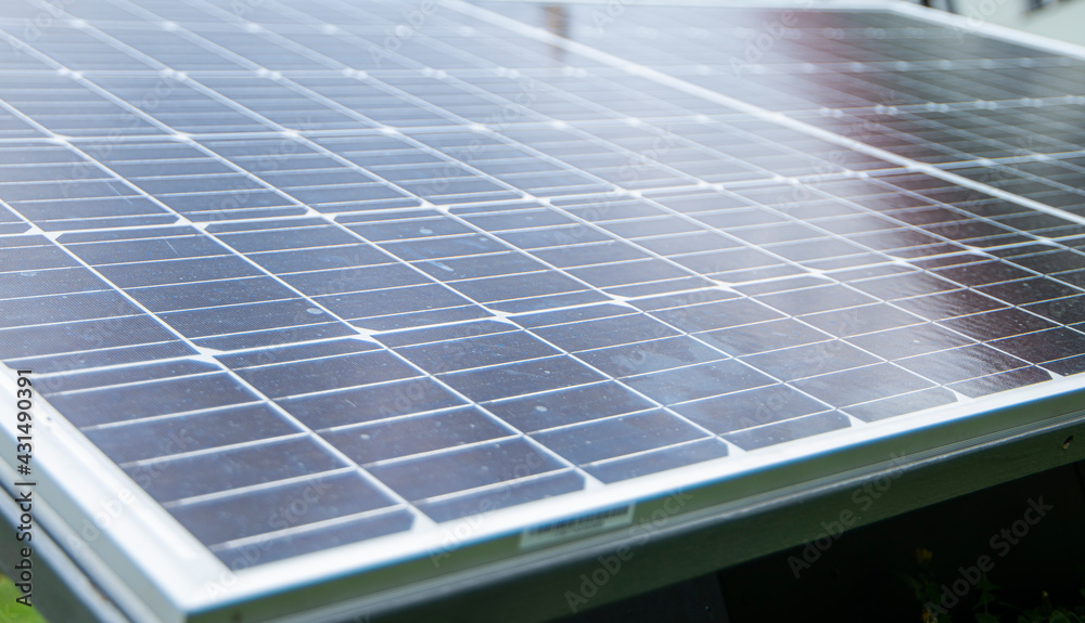 dirty and dusty solar panels in a city park, green energy and ...